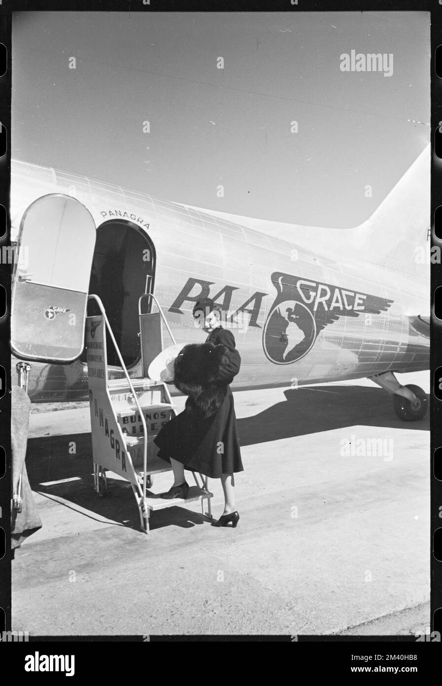 Woman holding a fur coat and sombrero boarding a Pan American-Grace ...