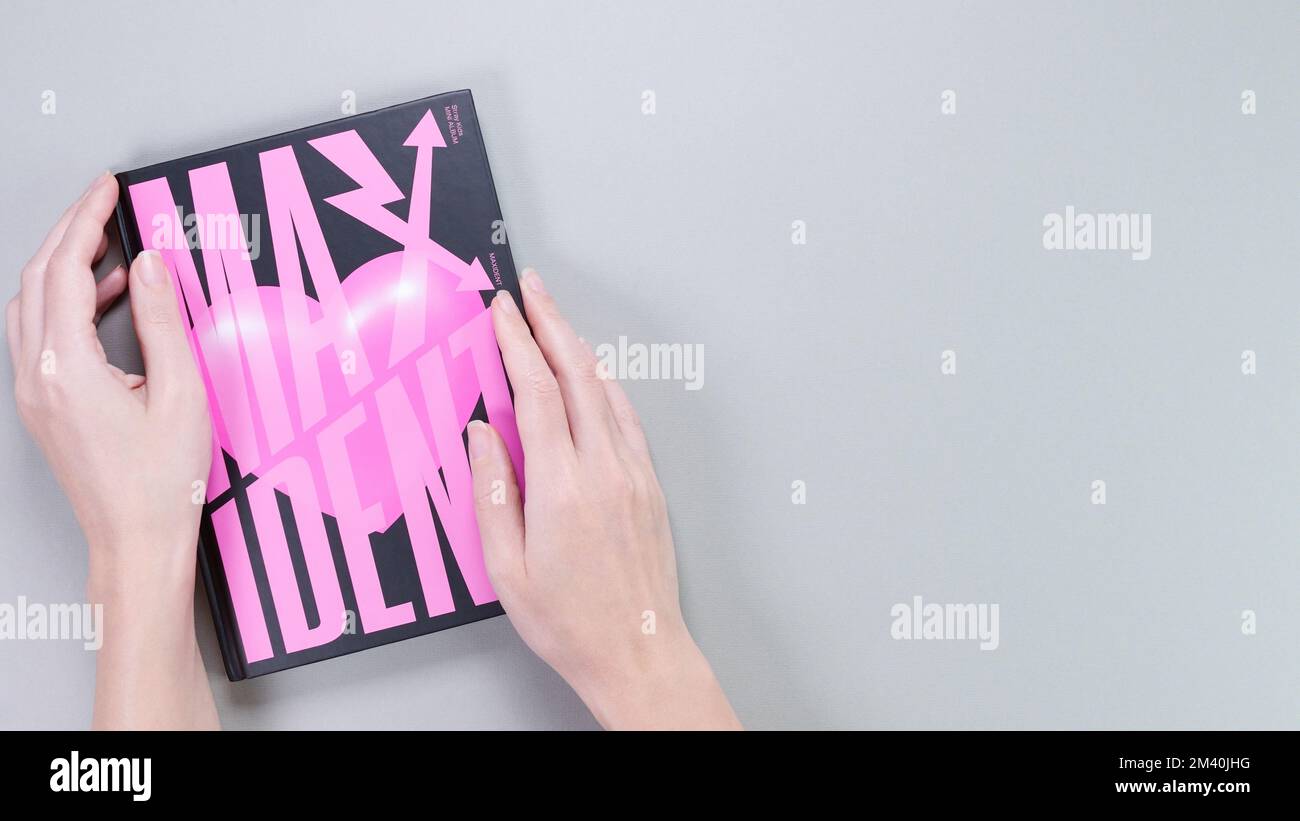 Hands holding Stray Kids MAXIDENT mini Album Box set on grey. Pink ...