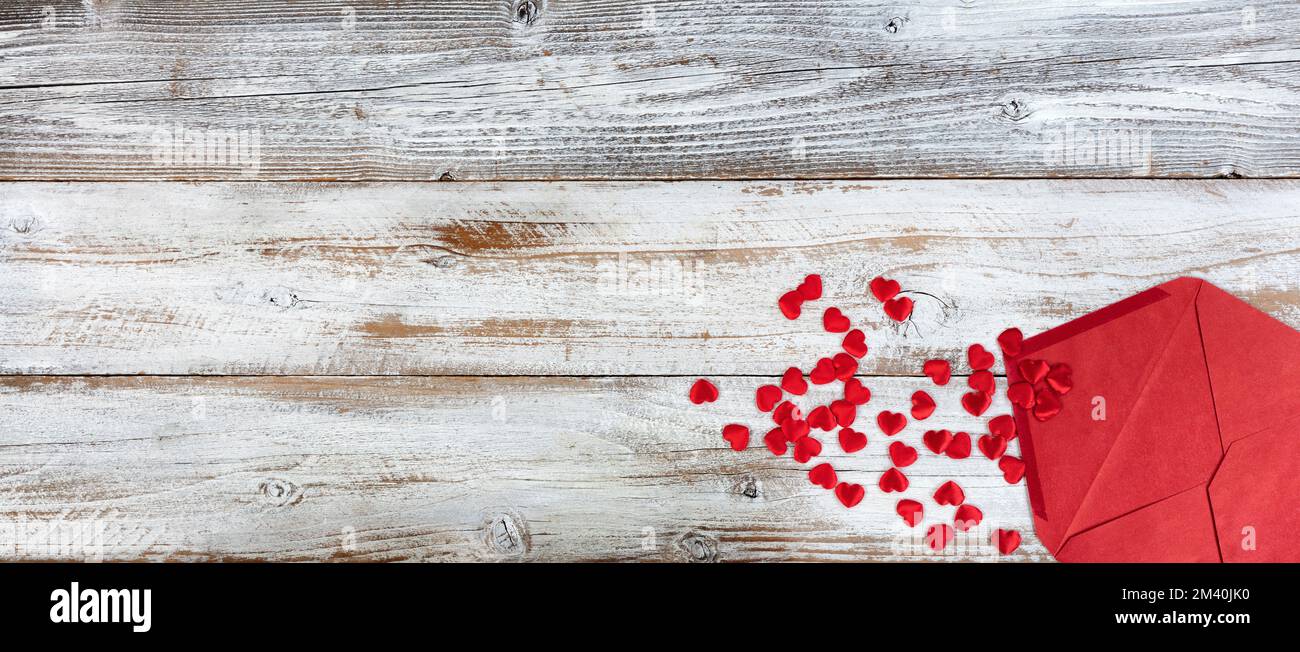 Valentines day greeting concept with envelope and small red hearts on ...