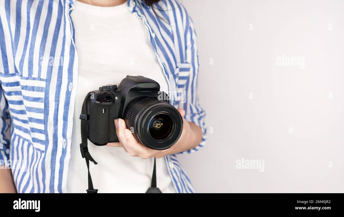 Photographer holding dslr camera. Self portrait, front view. Faceless ...