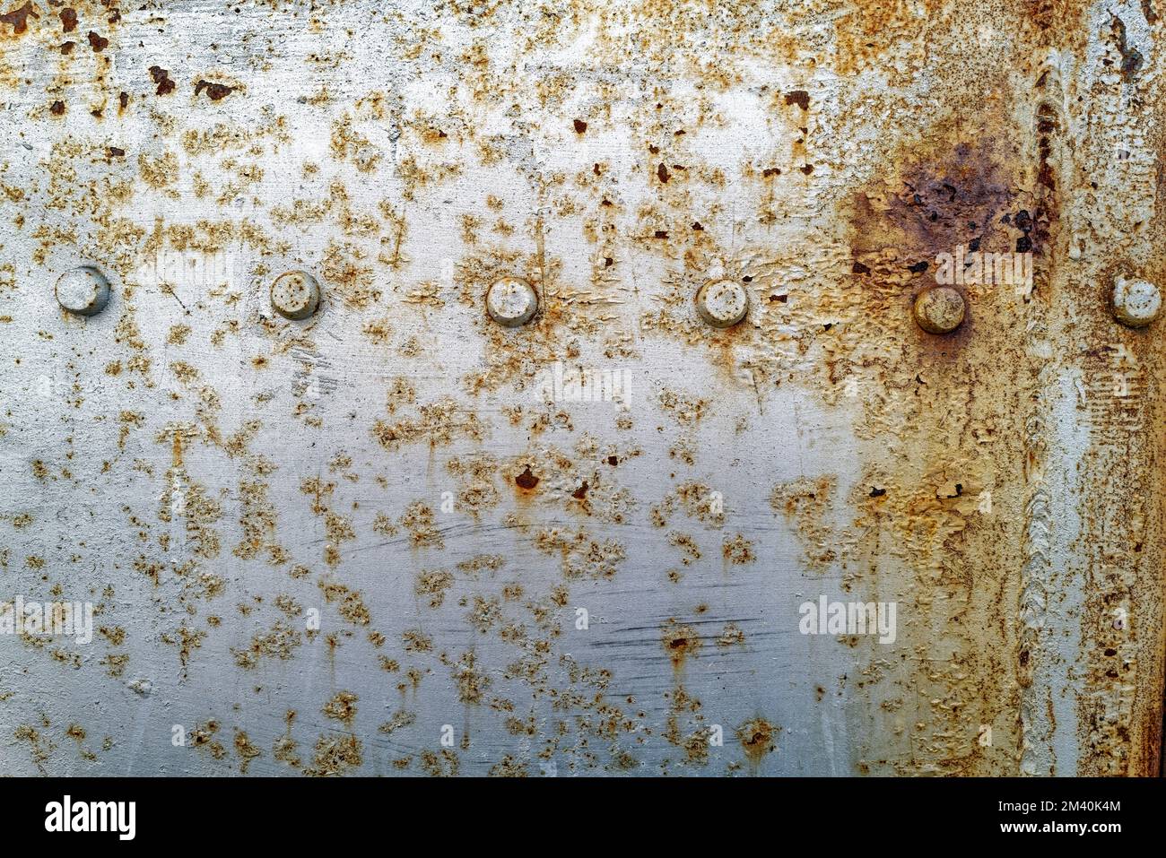 Detail of rusty metal surface with a line of bolts Stock Photo - Alamy