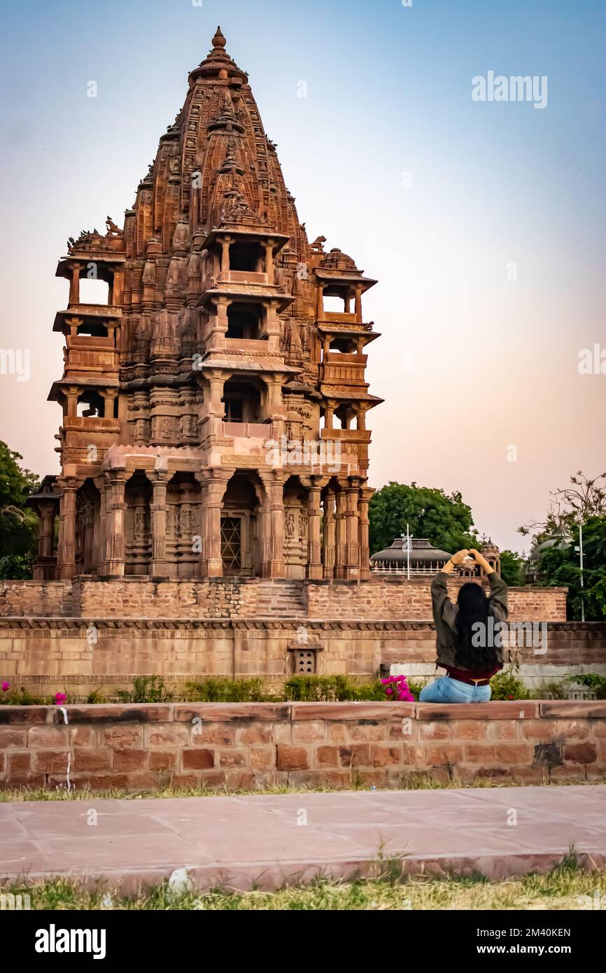 ancient hindu temple architecture with girl witnessing it at evening ...