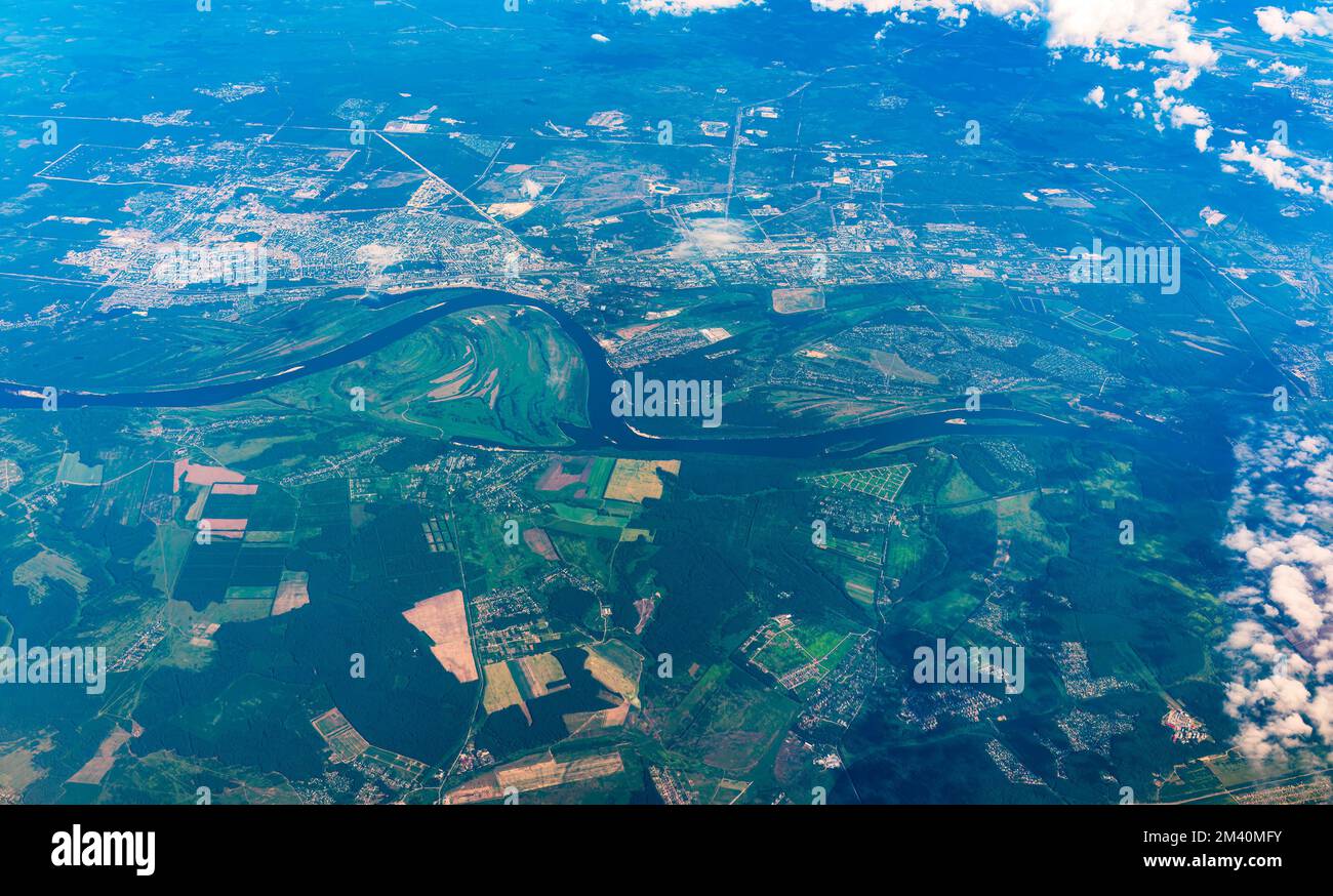 Aerial view from airplane window above green ground. View from the ...