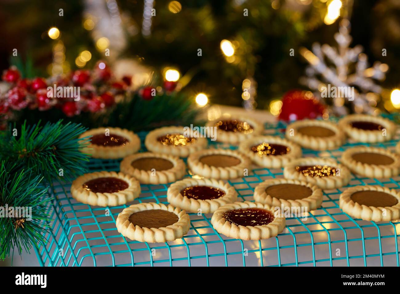 Christmas cookies with jam and hazelnut spread are cooling on wire rack ...