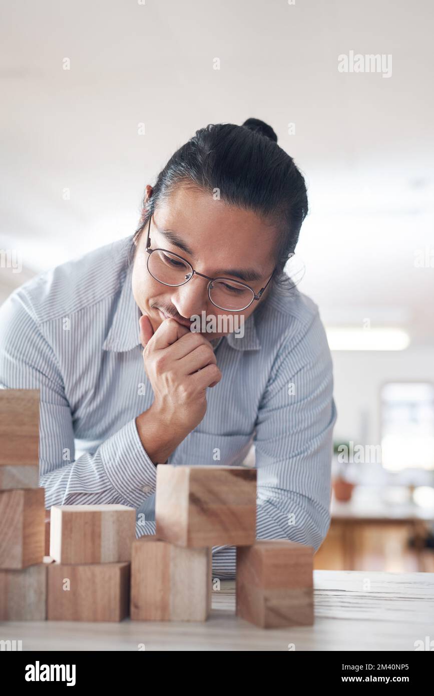 Imagination is the basis of invention. a young businessman working with ...