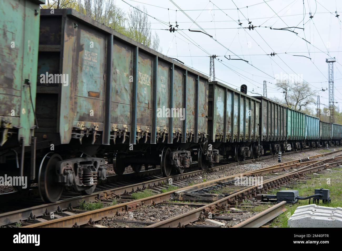 Heavy industry, heavy freight railway loading metal wagons pass along ...