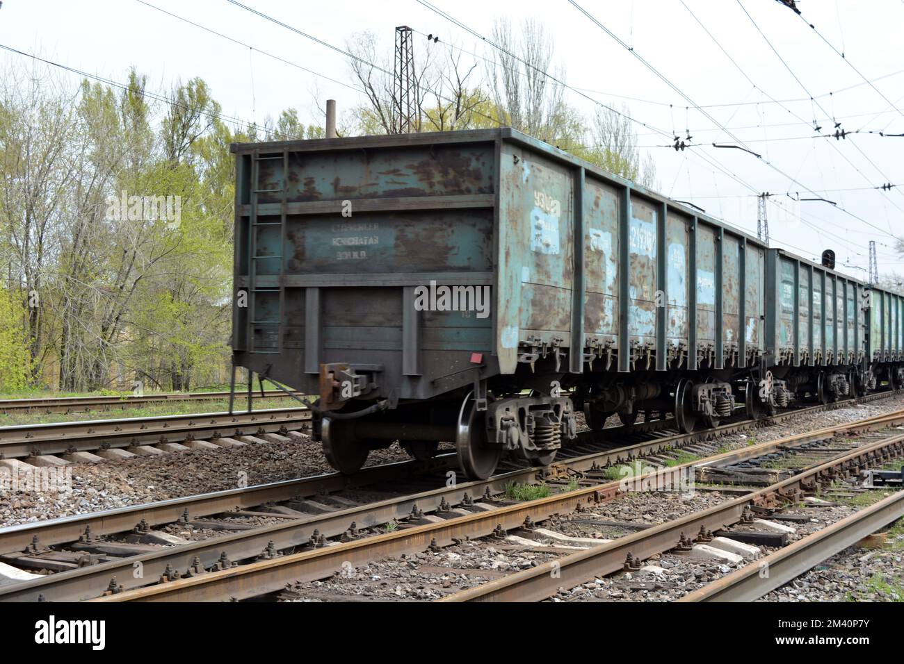 Heavy industry, heavy freight railway loading metal wagons pass along ...