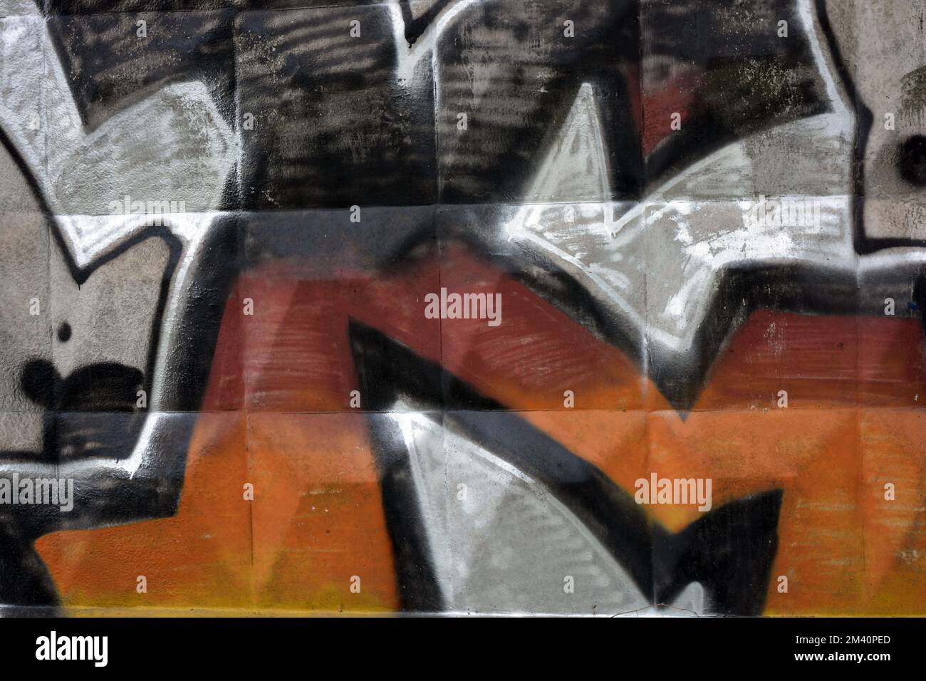 Graffiti word KS, drawn by a lapdog in grey, black and onange letters ...