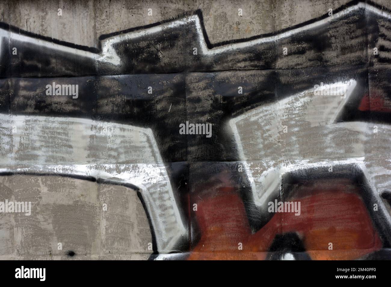 Graffiti word F, drawn by a lapdog in grey, black and onange letters ...