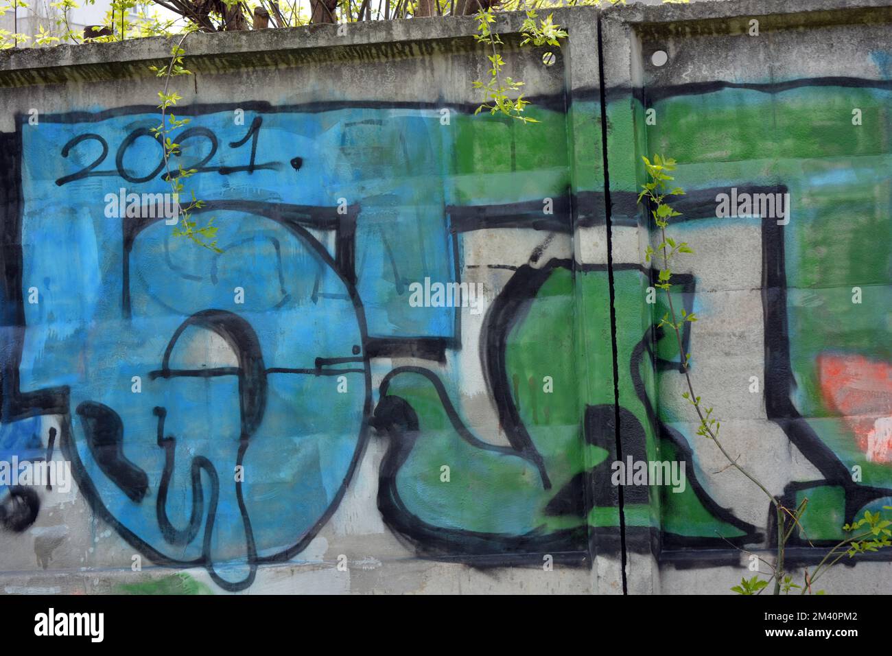 Unusual wall graffiti along the entire concrete fence in the form of ...