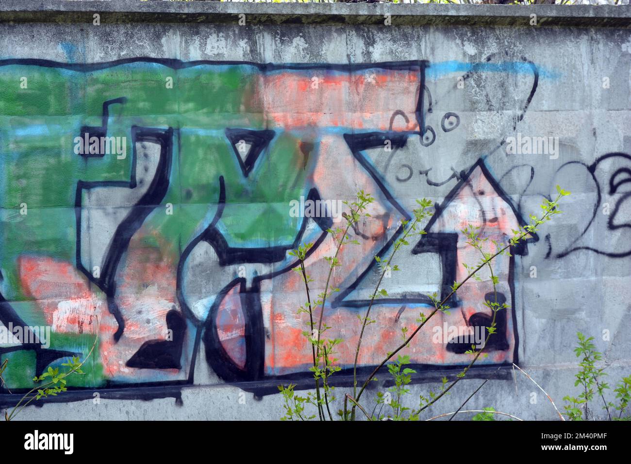 Unusual wall graffiti along the entire concrete fence in the form of ...