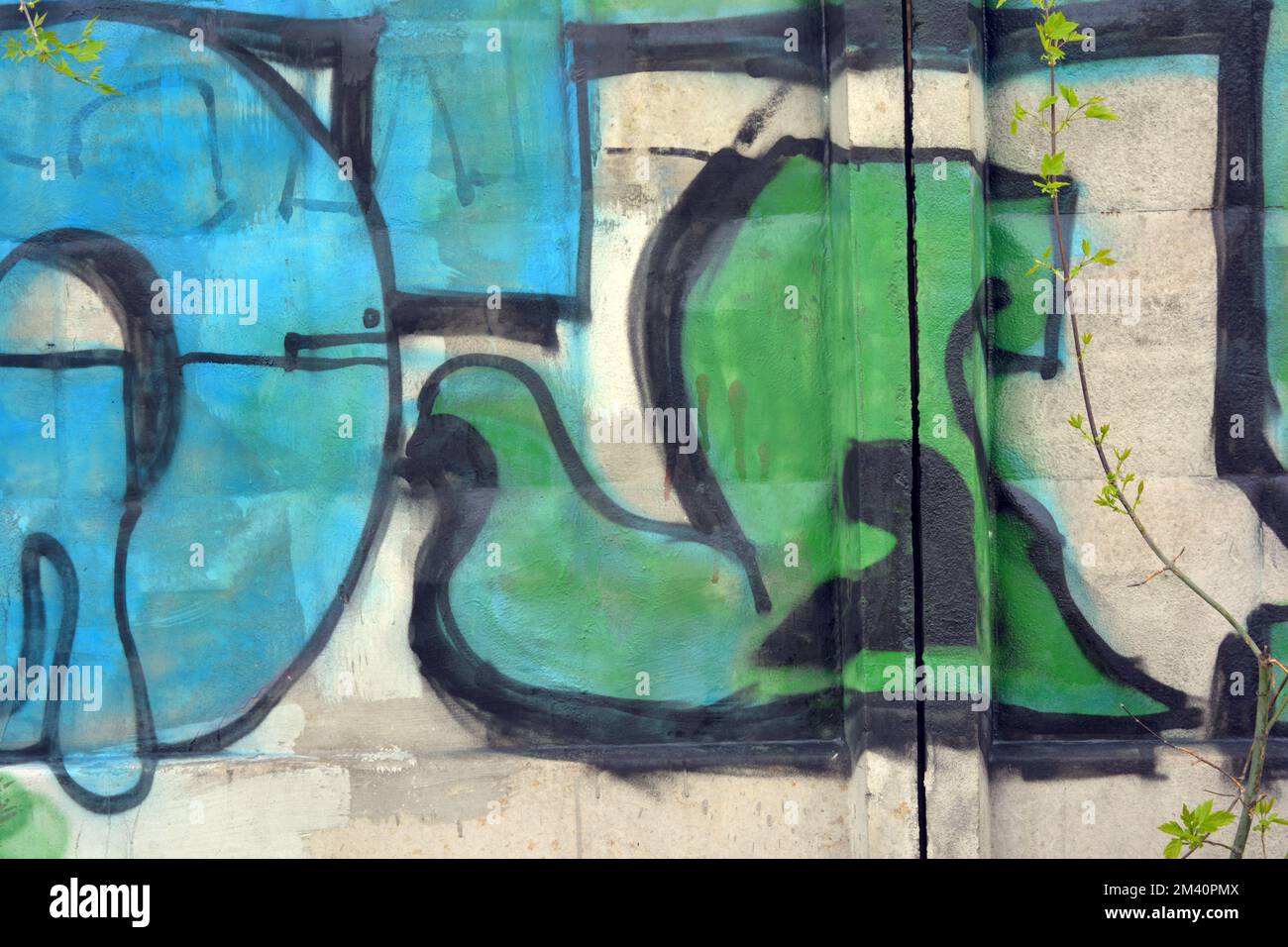 Unusual wall graffiti along the entire concrete fence in the form of ...