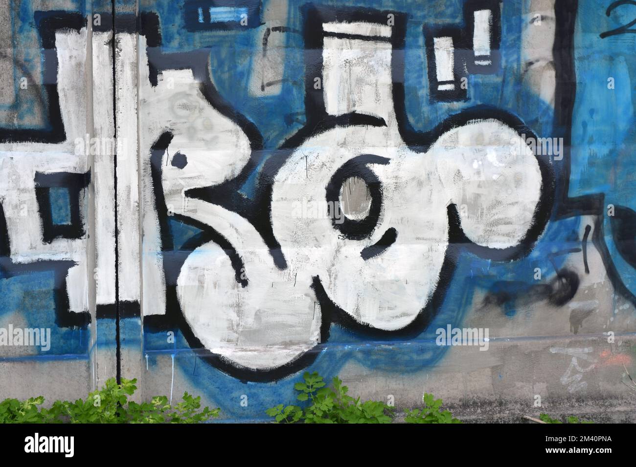 Specific graffiti painted with a can of white and blue colors with a ...