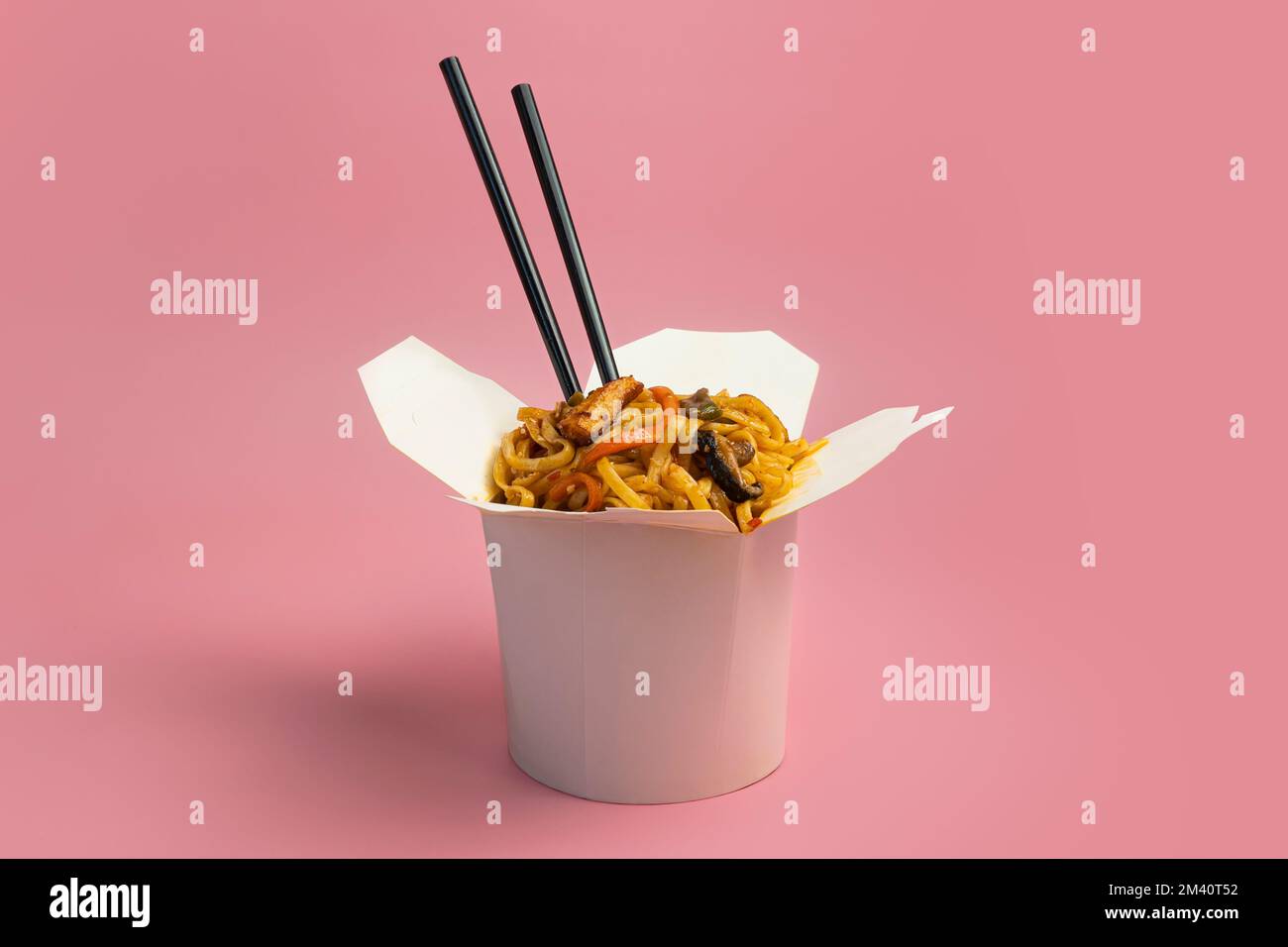 Box with Thai food. Noodles with chicken, mushrooms and vegetable on a ...