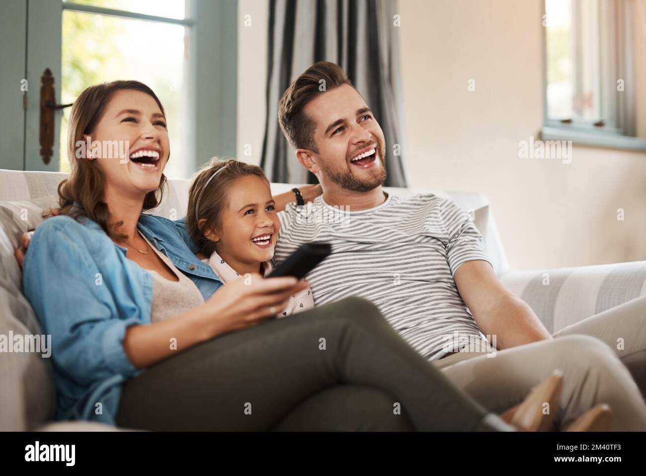 Laughing family watching tv on hi-res stock photography and images - Alamy