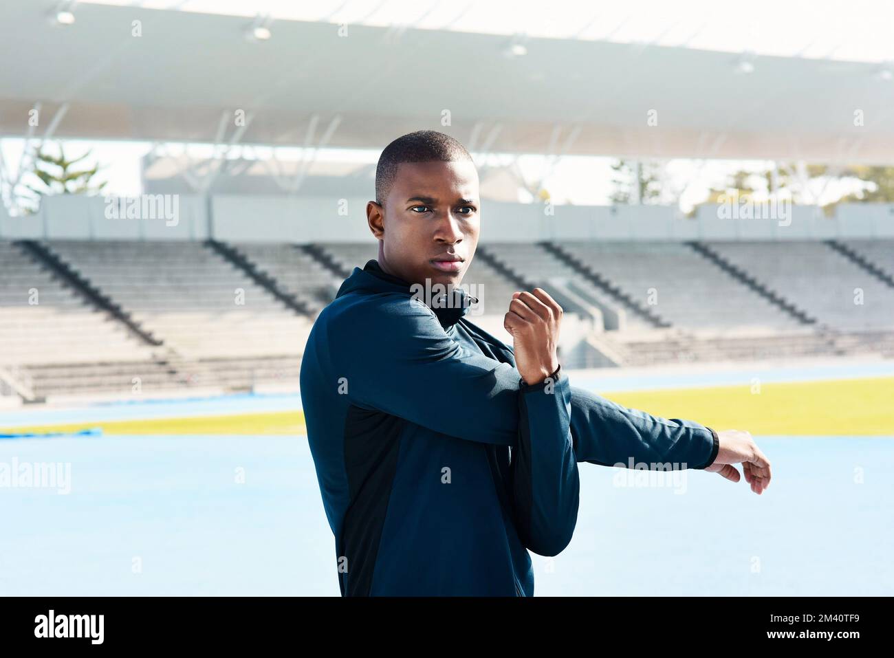 The all important warmup. a handsome young male athlete warming up out ...