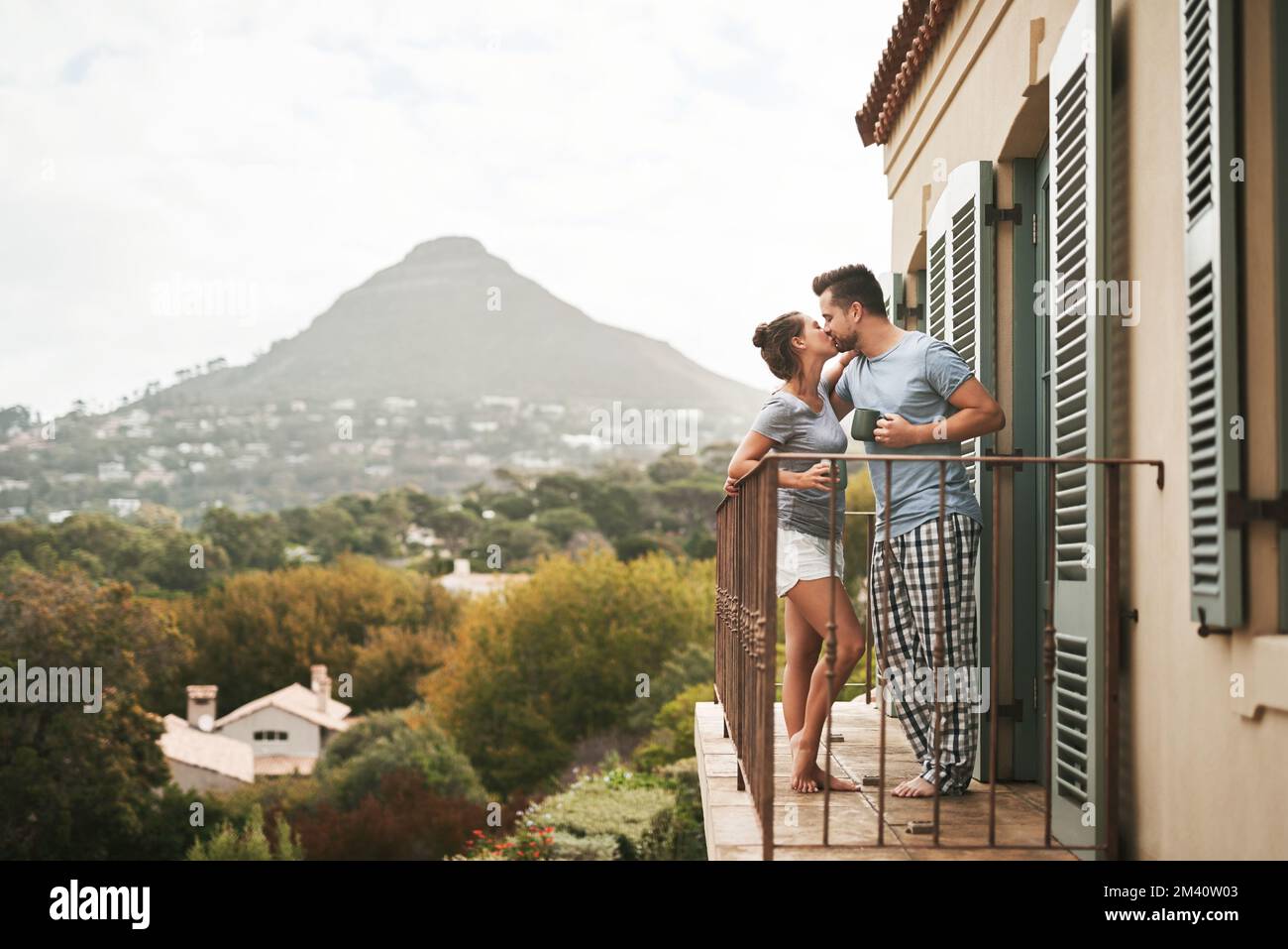 Couple kissing on balcony in hi-res stock photography and images - Alamy