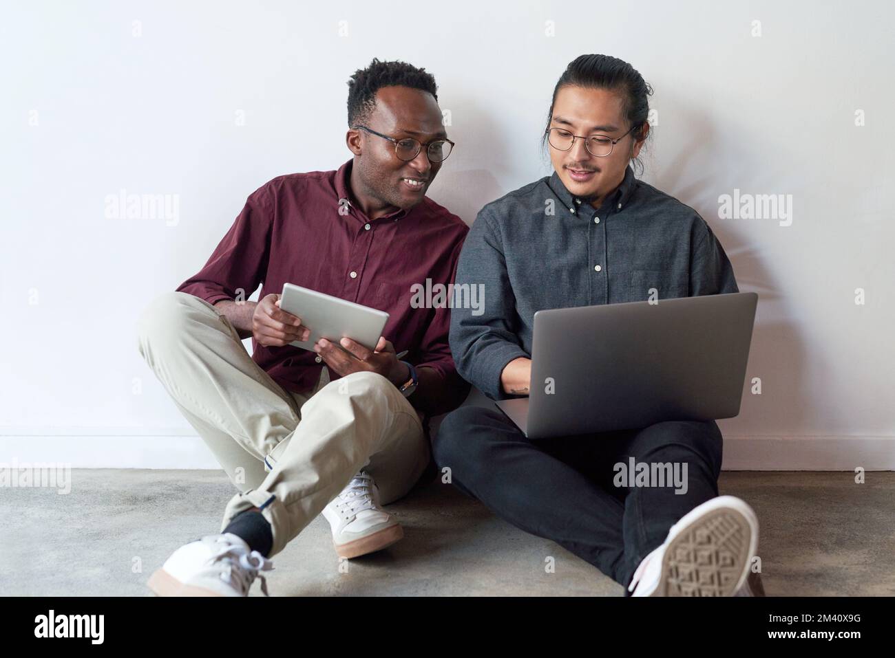 We always keep ourselves in the loop. Full length shot of two young ...