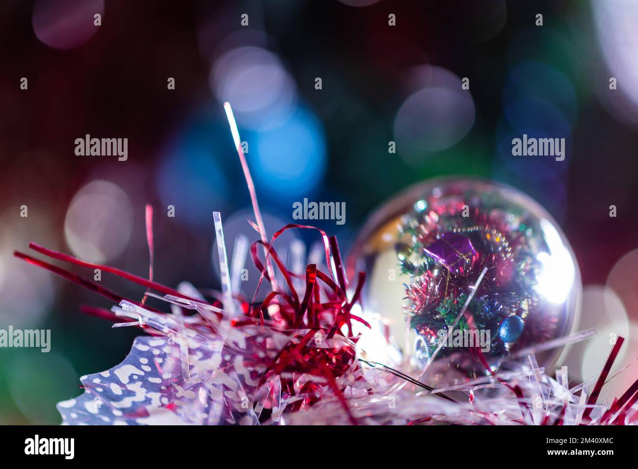 Christmas decorations on a tree through lens ball, macro shot close-up ...