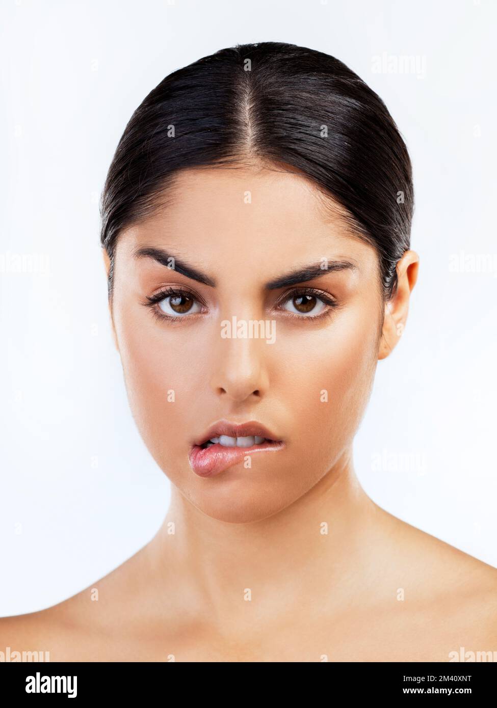 Beauty with a bit of a bite. Studio shot of beautiful young women ...