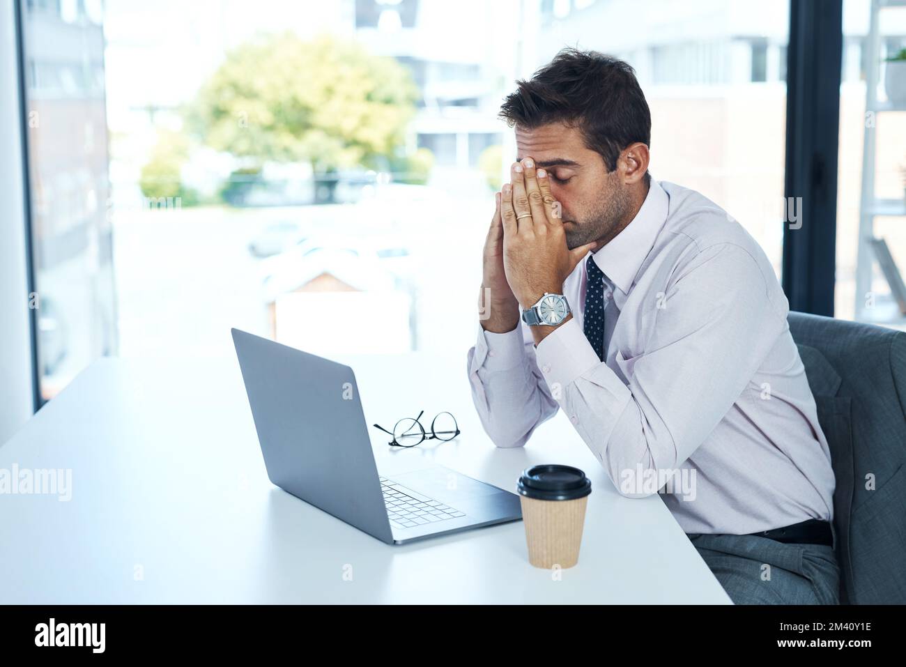 Work is stressing me out. a businessman looking stressed while sitting ...