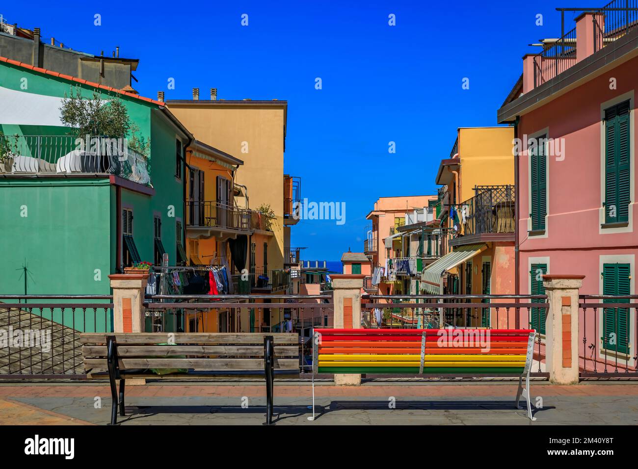 Public benches on a square overlooking traditional colorful houses in ...