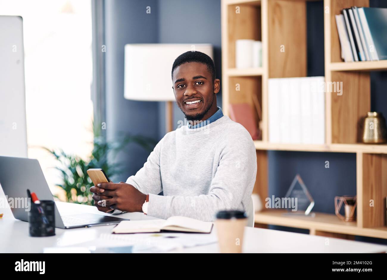 My career is really taking off. a young businessman using a smartphone ...
