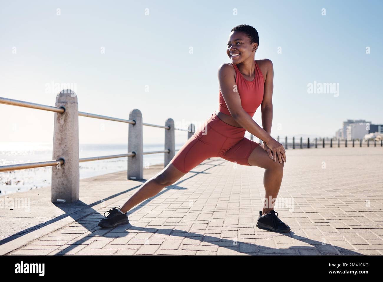 Black woman, stretching legs and beach fitness for exercise workout motivation or runner sports ...