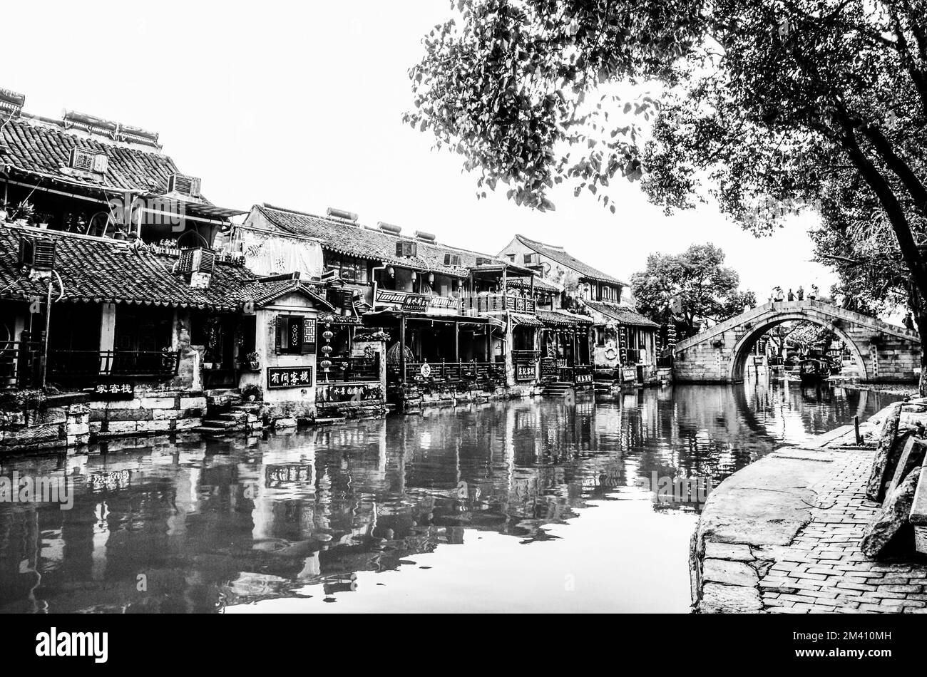 A grayscale shot of Chinese-style builidings by the pond in Xitang ...