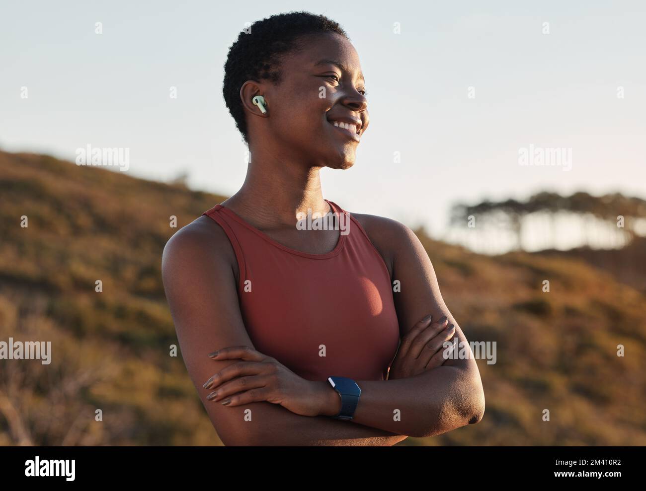 Black woman runner, smile and music with earphones, nature and hill for ...