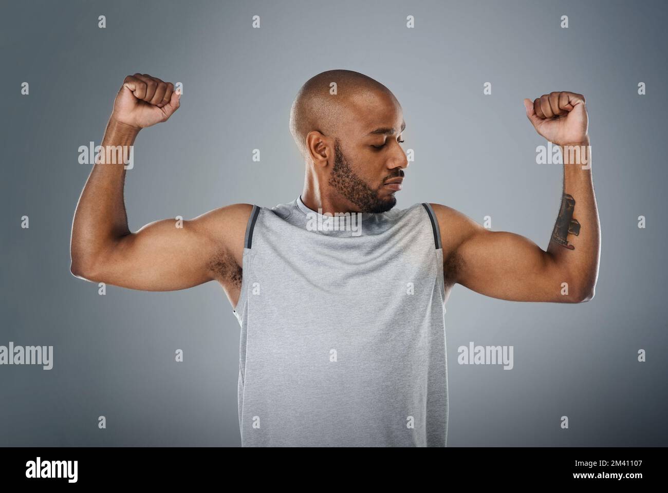 Im strong and thats enough. a sporty young man flexing his muscles ...