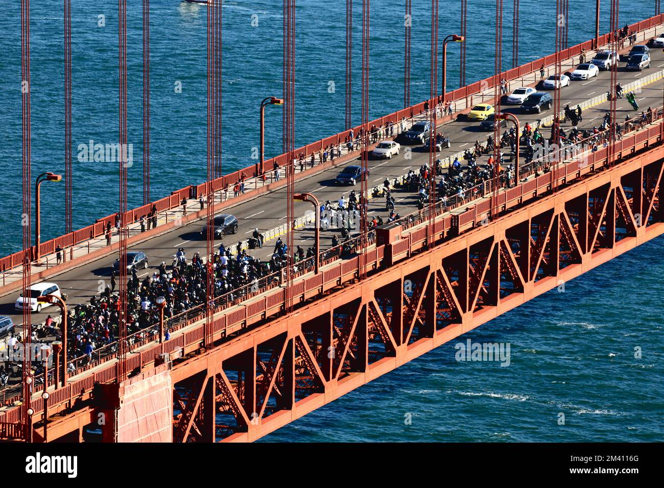 An aerial view of Golden Gate Bridge with traffic vehicles and people ...