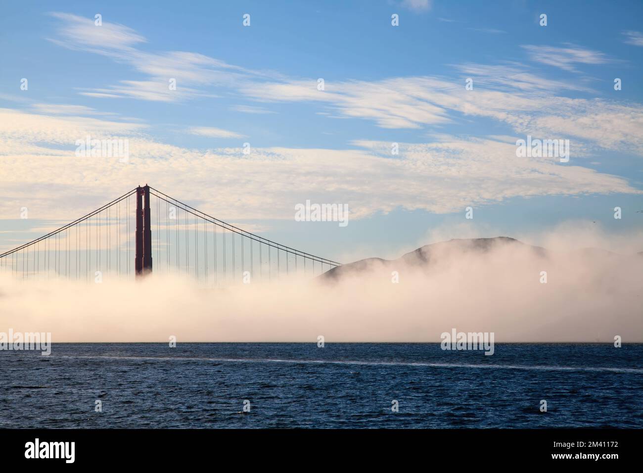 A beautiful foggy view of the Golden Gate Bridge in San Francisco with ...