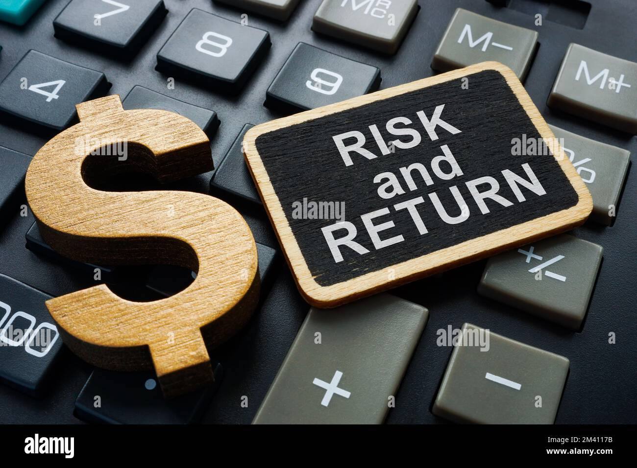 Calculator with plate risk and return and dollar sign Stock Photo - Alamy