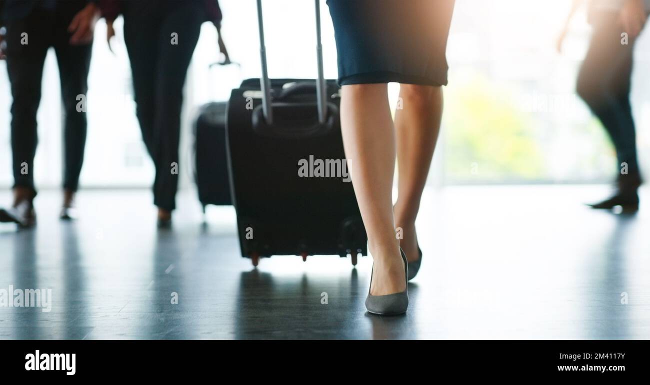 Always on the move. Low angle shot of an unrecognizable woman walking ...