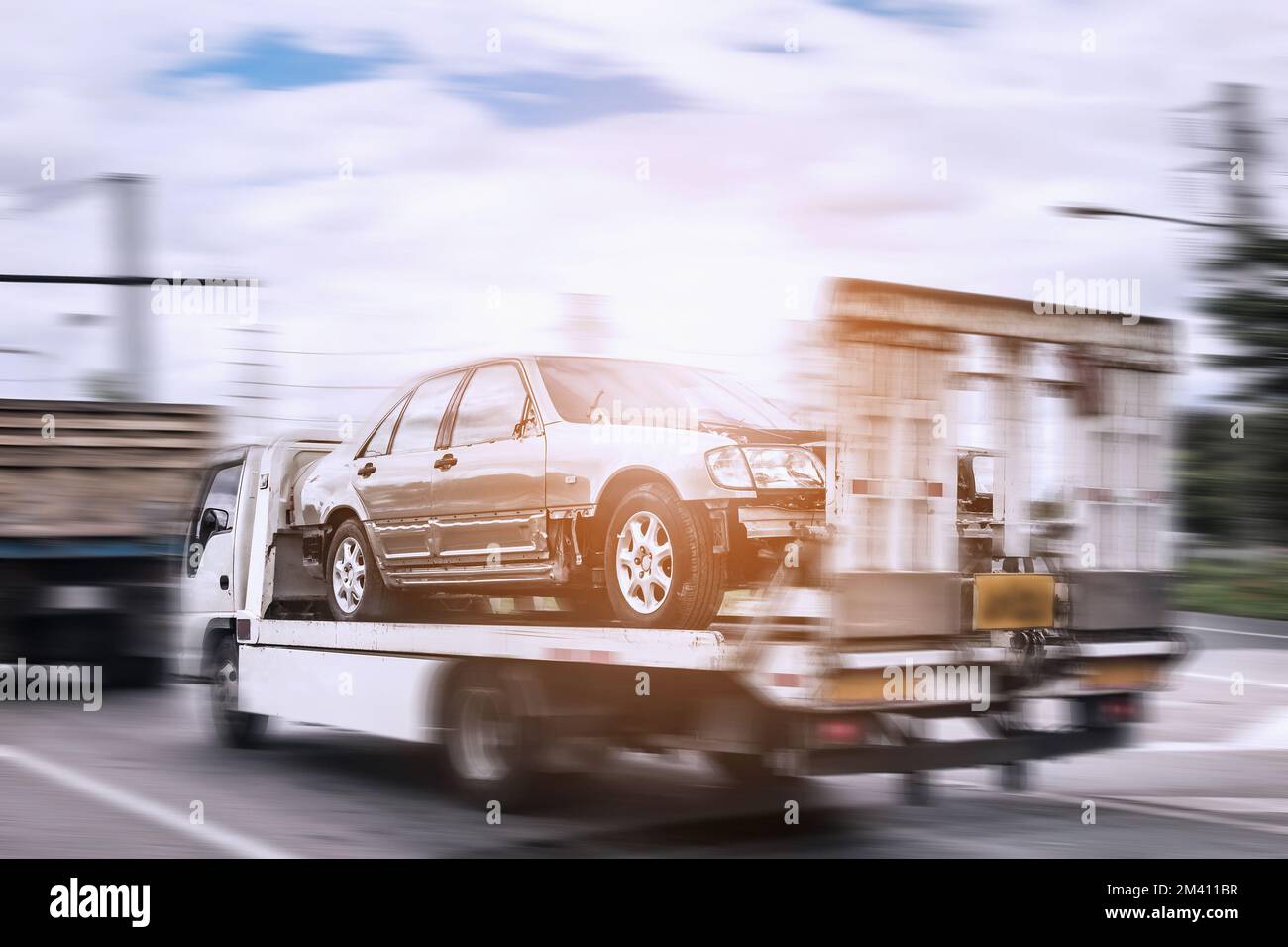 Broken car on tow truck after traffic accident, on the road service ...