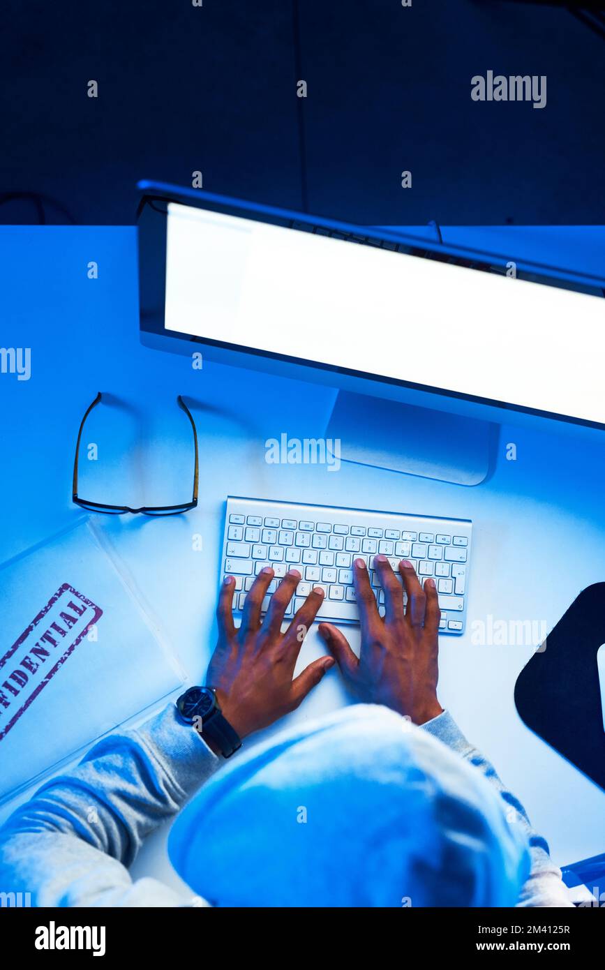 Getting ready for cyber warfare. High angle shot of a young male hacker ...