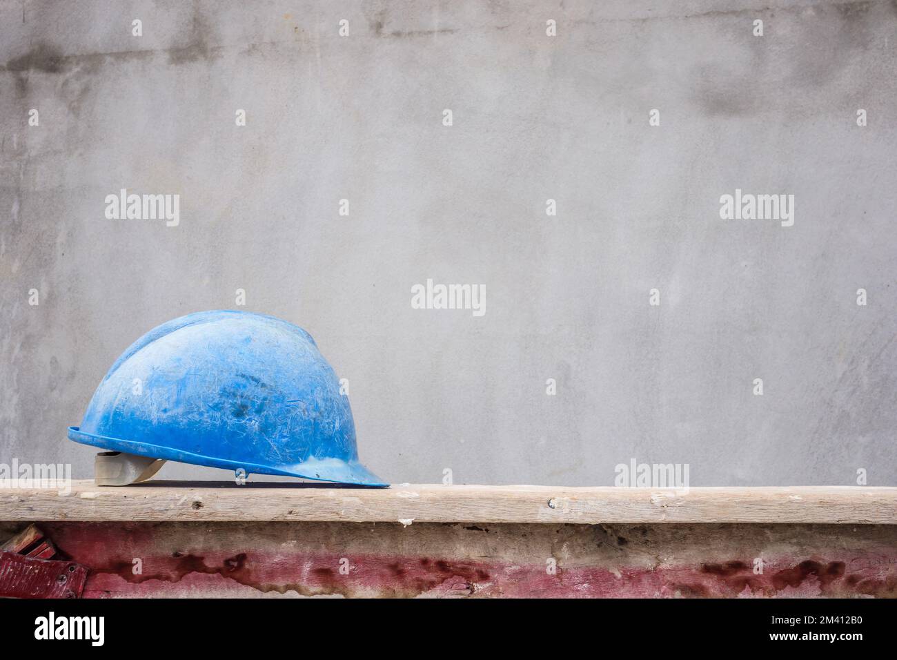 Blue hard hat on house building construction site Stock Photo - Alamy