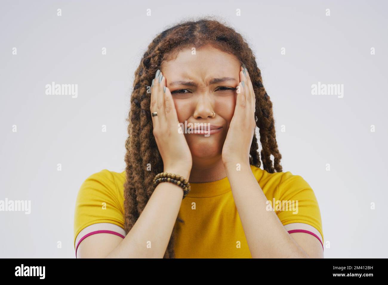 What am I going to do. Studio shot of a young woman crying while ...
