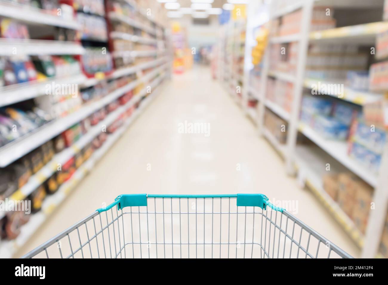 Empty shopping cart with abstract blur supermarket discount store aisle ...