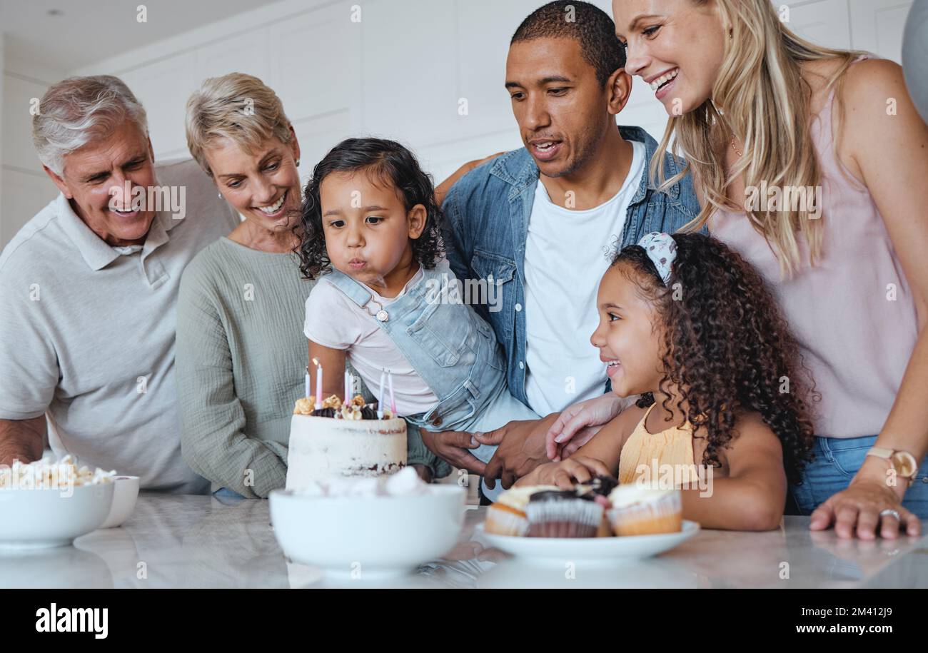Big family, birthday cake and blowing candles for a wish at home with ...