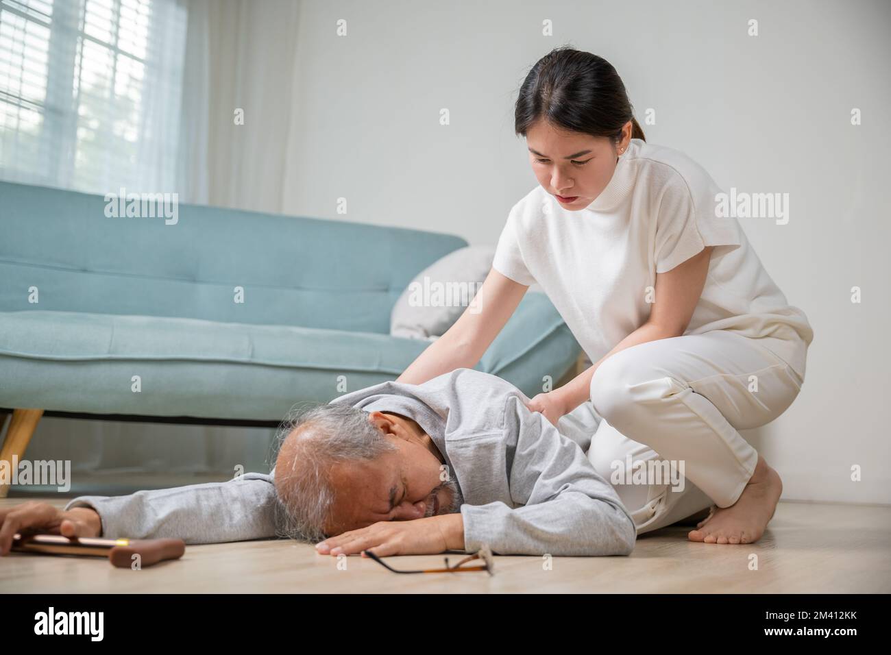 Asia young woman halping her father after falling down on floor Stock ...
