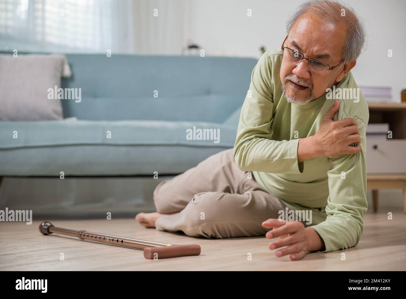 Asian senior man falling down lying on floor at home alone with wooden ...