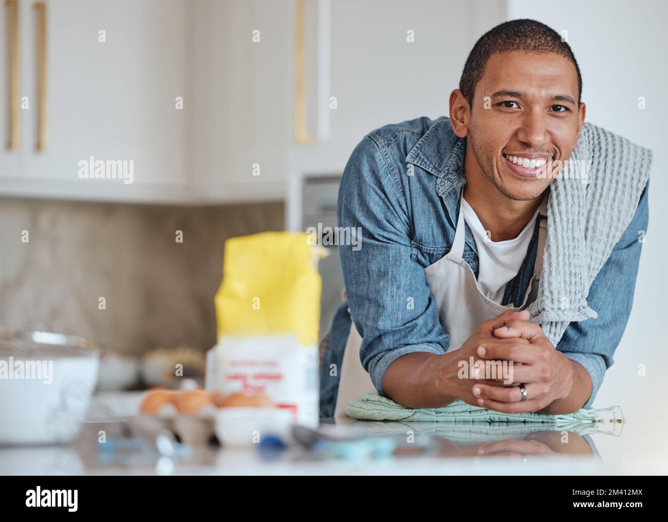 Happy man, face and smile while cooking in home kitchen with happiness ...