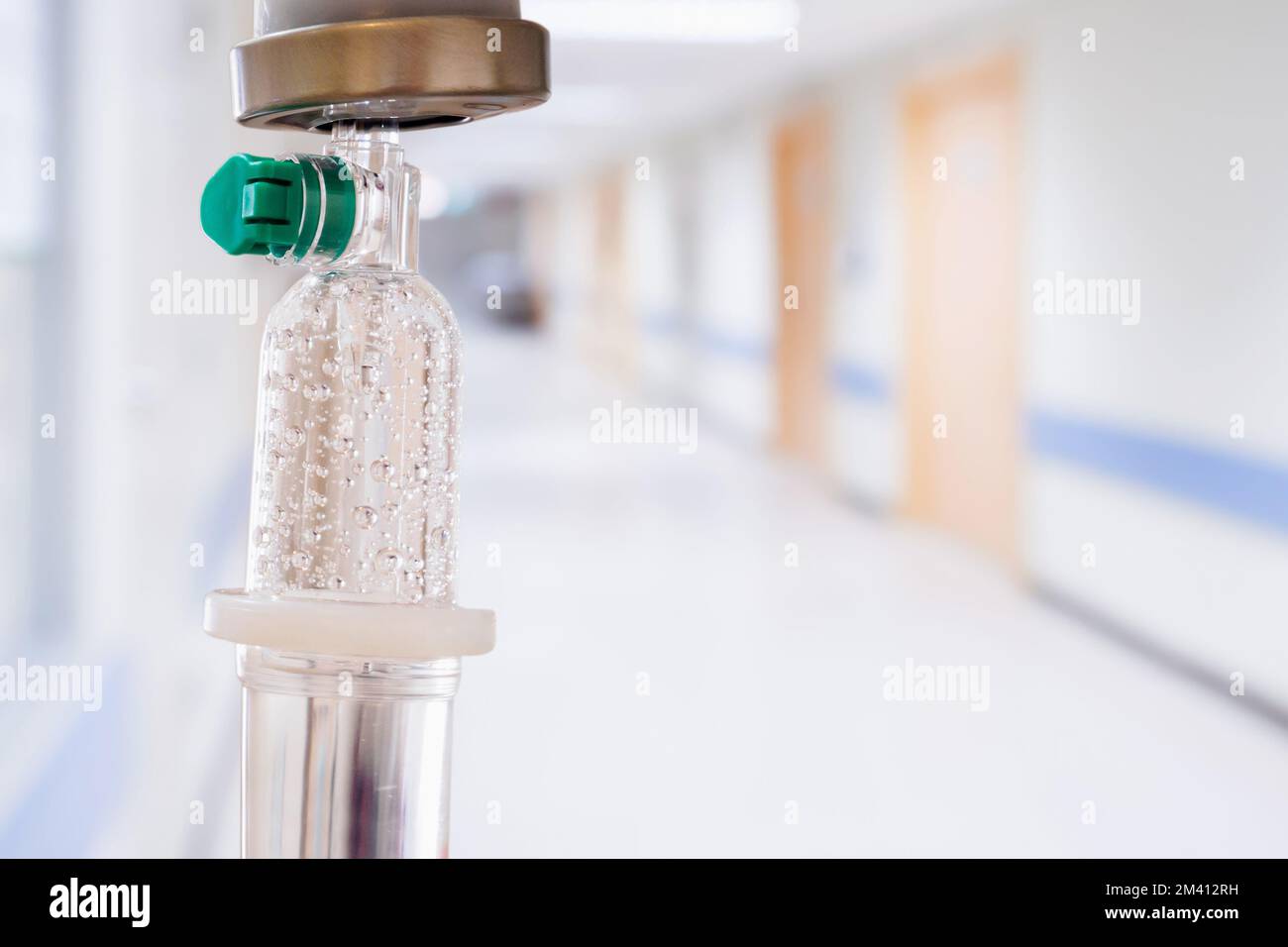 Medical drip with hospital blurred background Stock Photo - Alamy