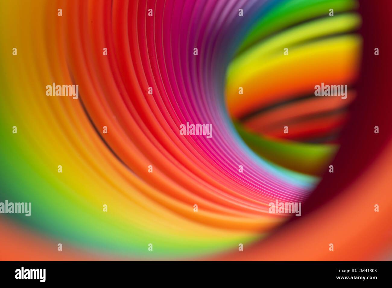 A closeup of rainbow-colored vibrant slinky Stock Photo - Alamy