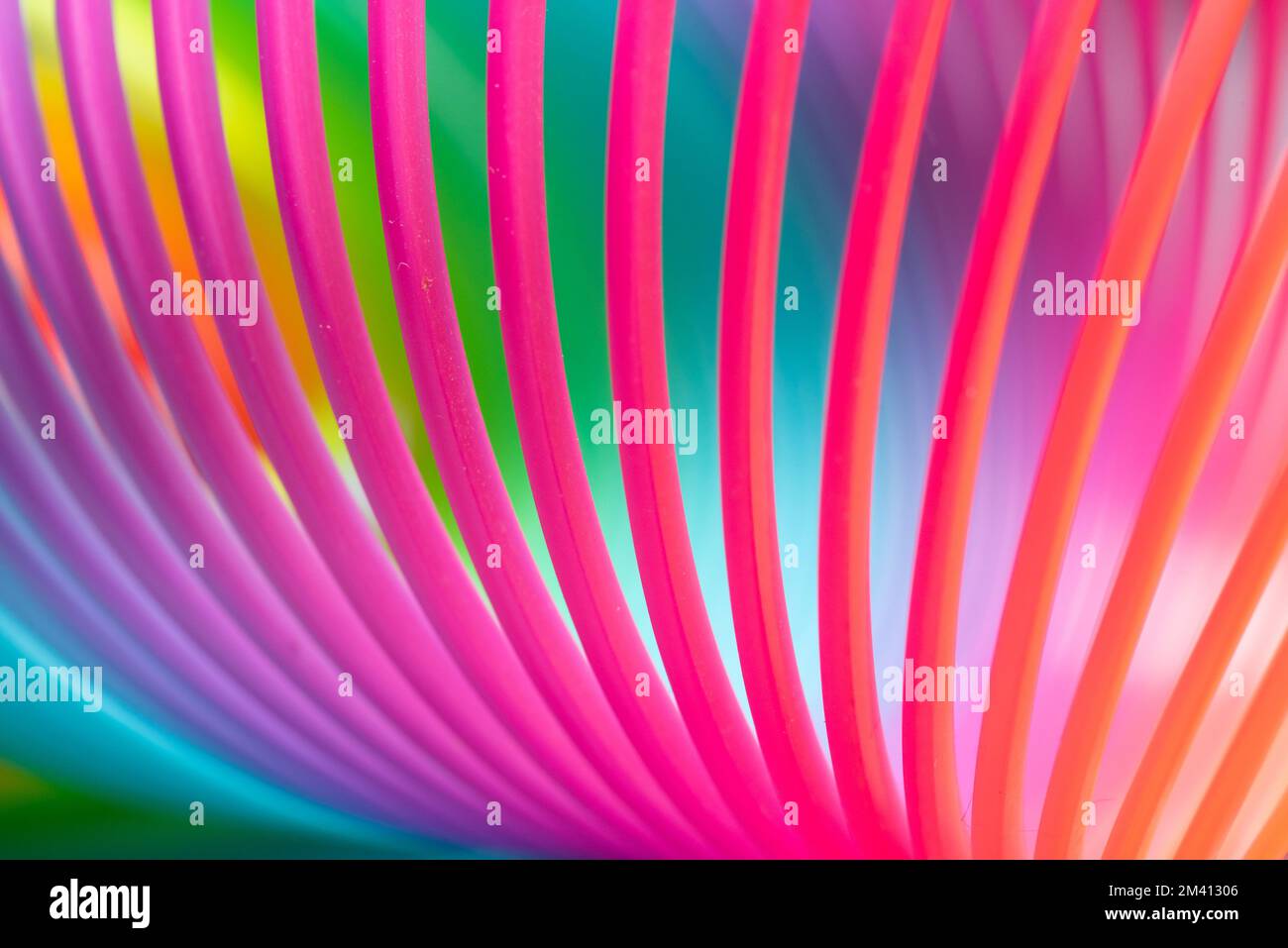 A closeup of rainbow-colored vibrant slinky Stock Photo - Alamy