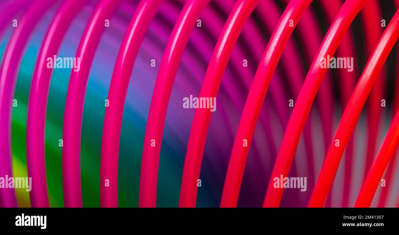 A closeup of rainbow-colored vibrant slinky Stock Photo - Alamy