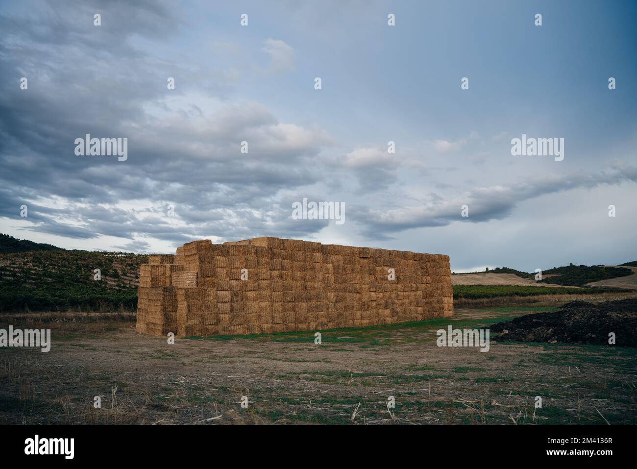 Stacked hay bales under a countryside summer sky. High quality photo ...