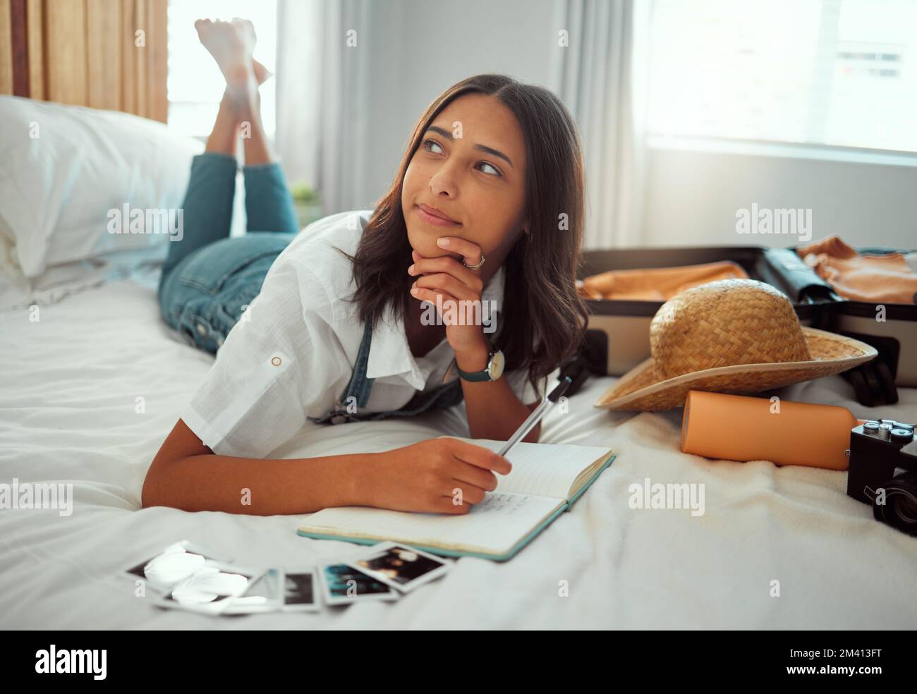 Thinking, travel luggage and woman with notebook planning global, world ...